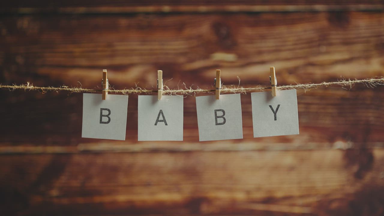 Letters spelling Baby hanging on a string - Free Stock Video