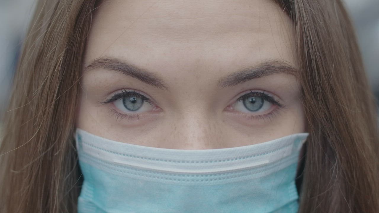 Detailed face of a girl with a face mask - Free Stock Video