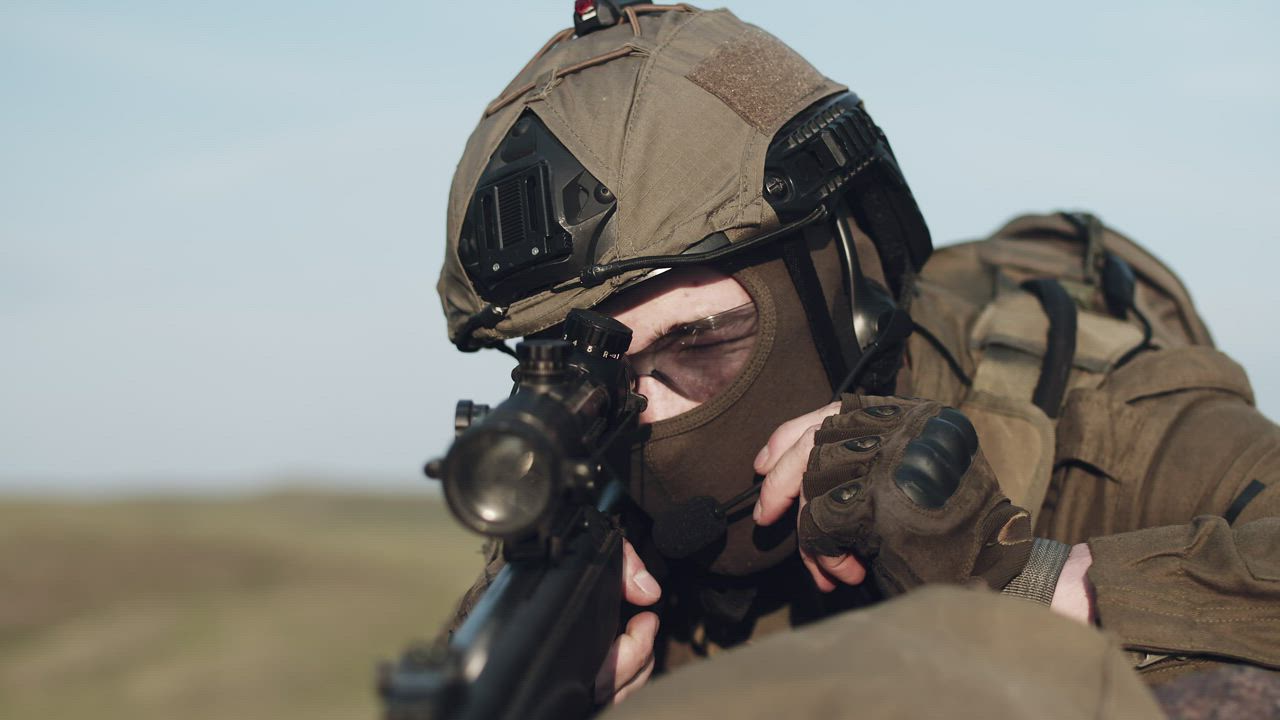 Soldier preparing a rifle on the battlefield - Free Stock Video
