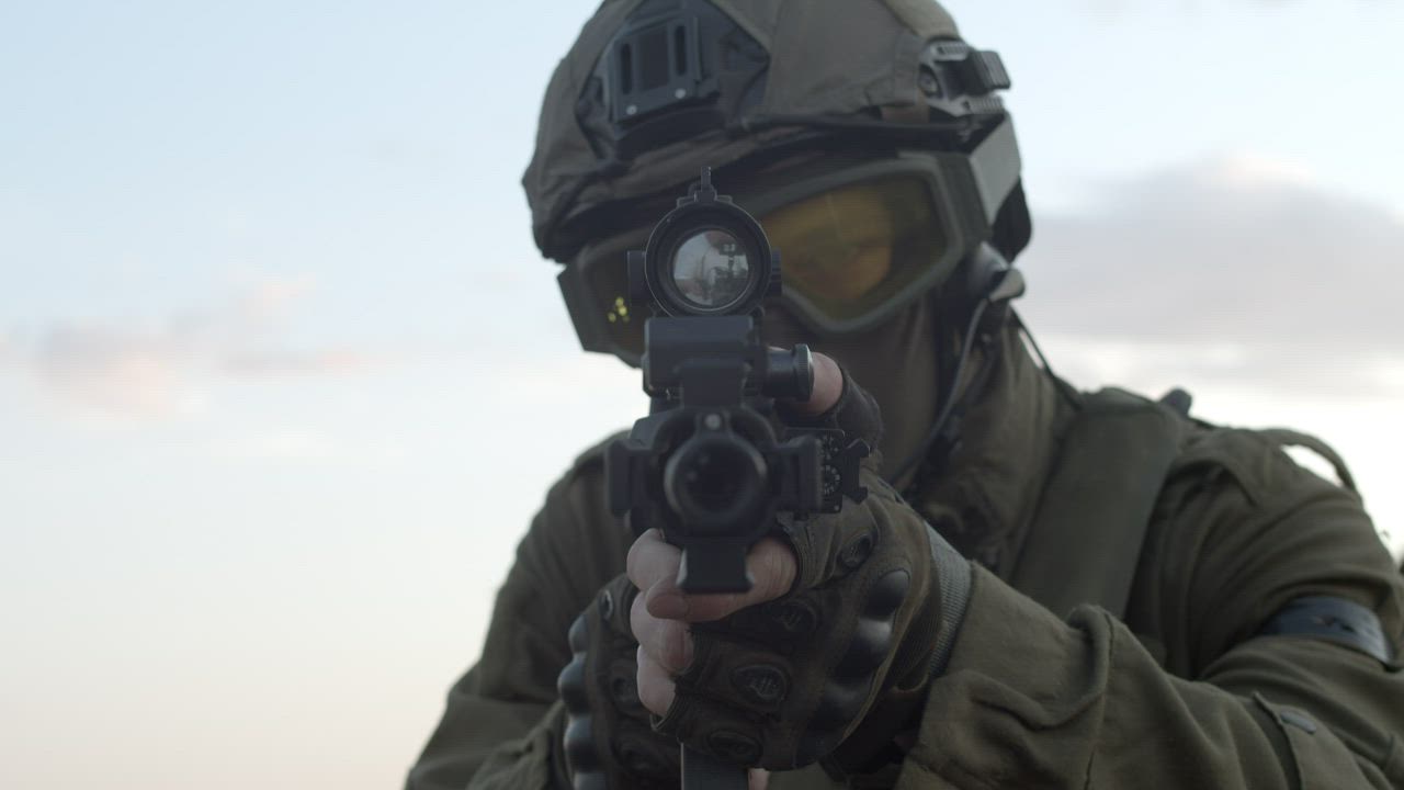 Armed military man points a gun at the camera - Free Stock Video
