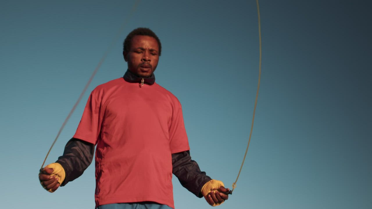 Man using a jump rope for exercise in the early morning - Free Stock Video