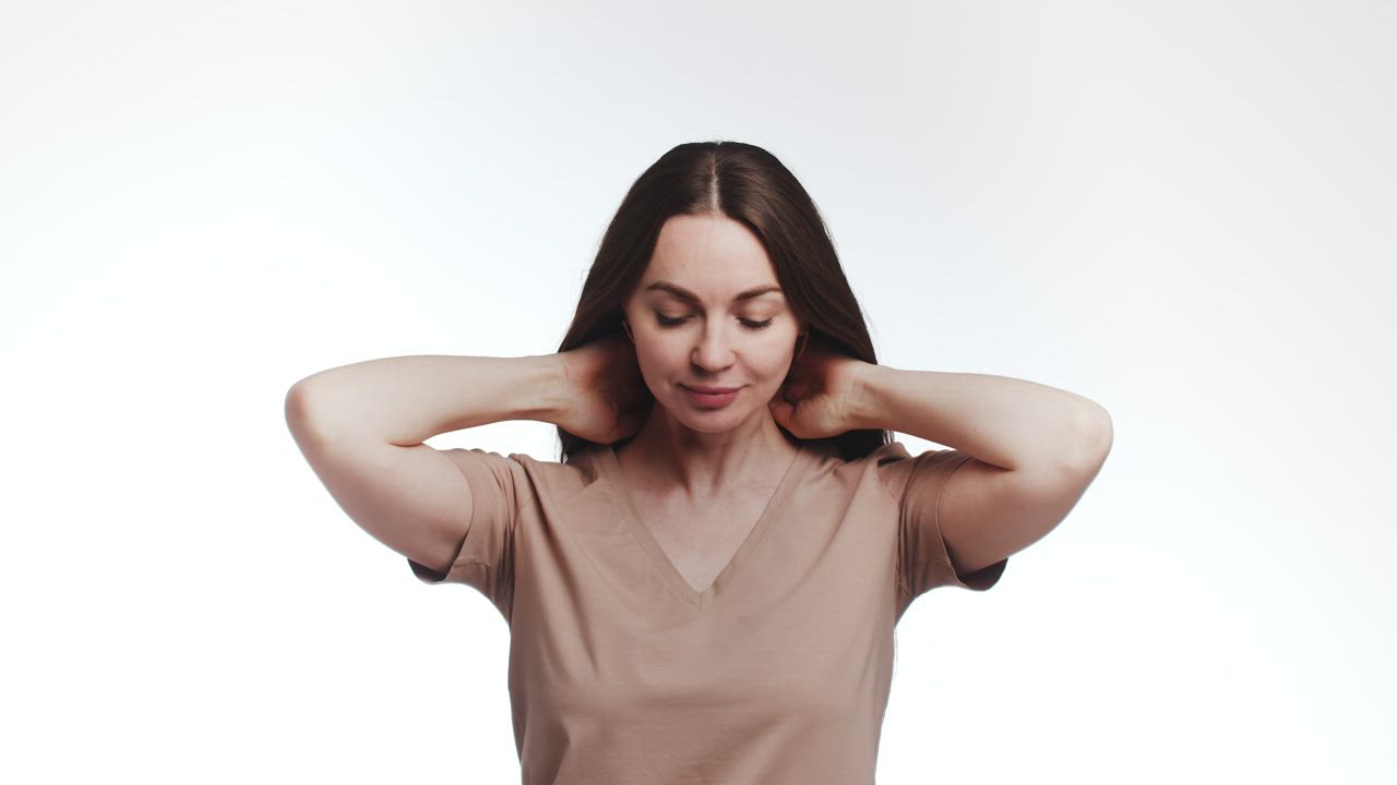 Woman flicking her long hair in a tan t-shirt - Free Stock Video