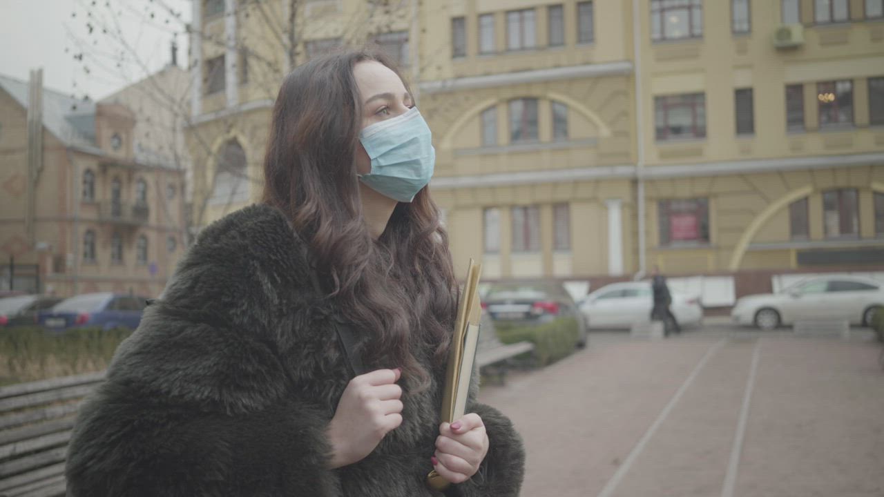 Woman wearing a face mask on the street - Free Stock Video
