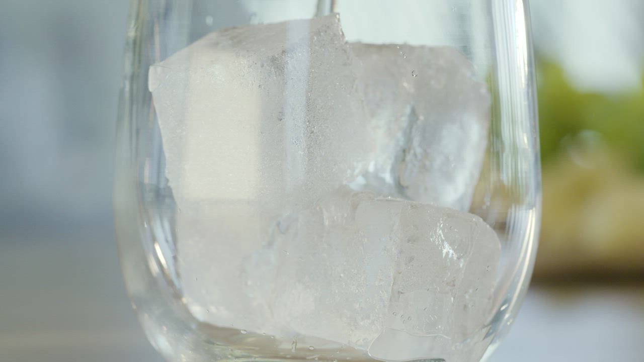 Mineral water pouring over ice in a glass - Free Stock Video