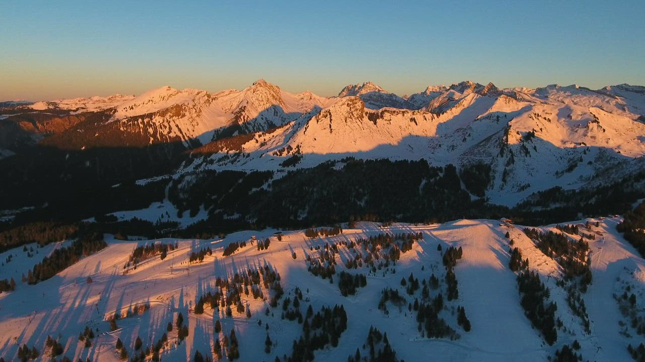 Gold sunset over snowy mountains - Free Stock Video