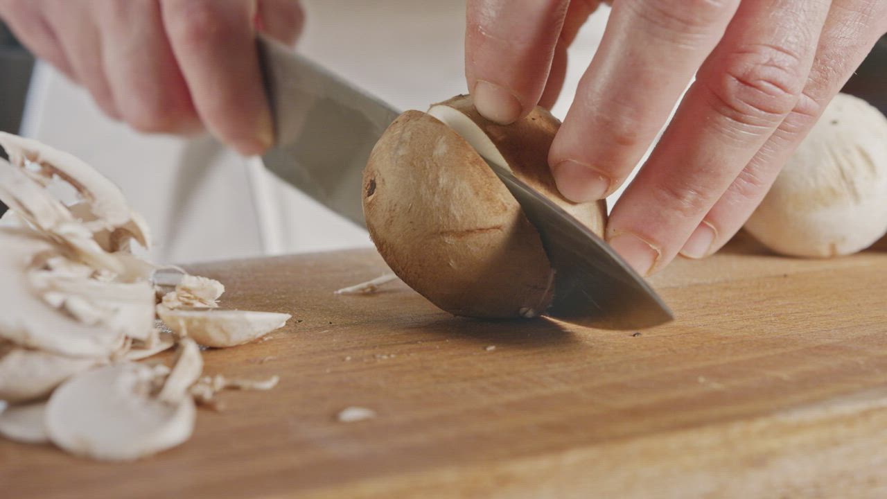 Cook's hands cutting mushrooms - Free Stock Video