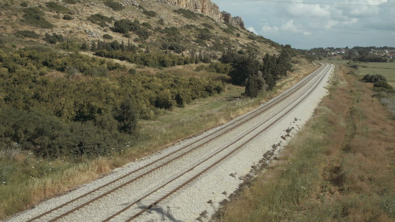 Passenger train running on tracks near the fields - Free Stock Video