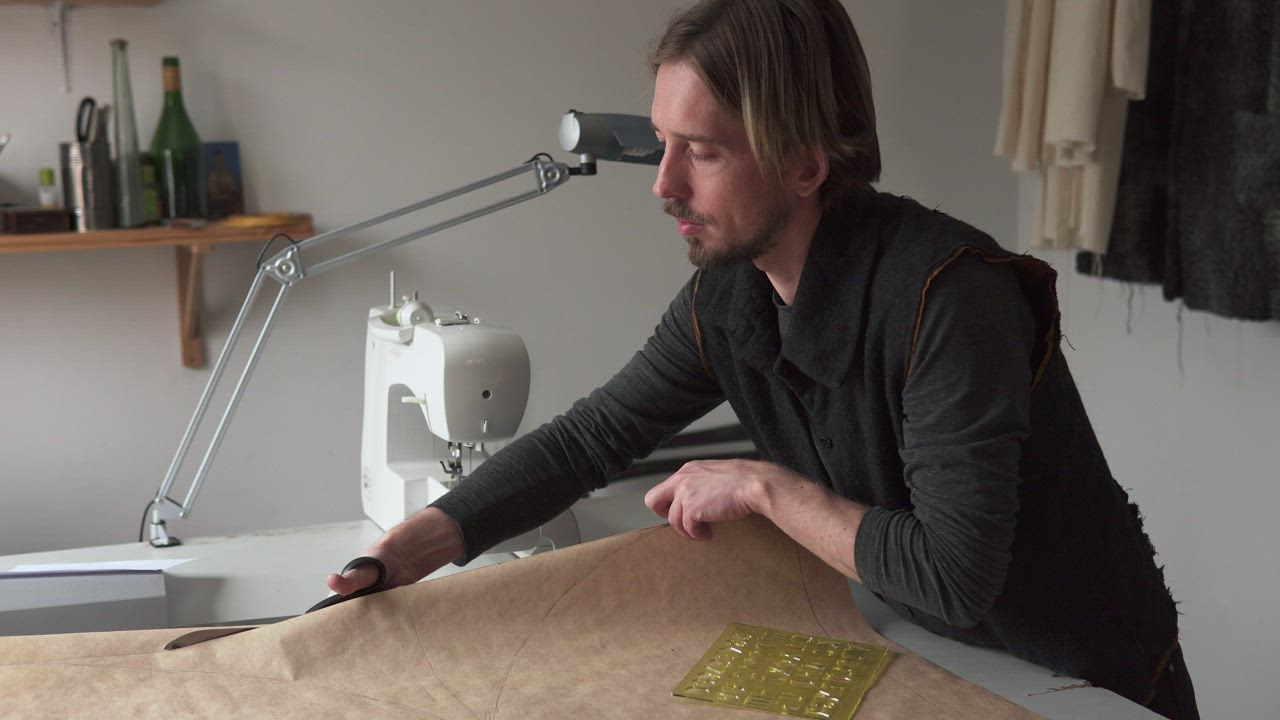 Fashion designer cutting a pattern for a dress - Free Stock Video