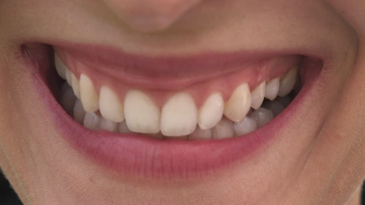 Close up of a woman smiling and showing teeth - Free Stock Video