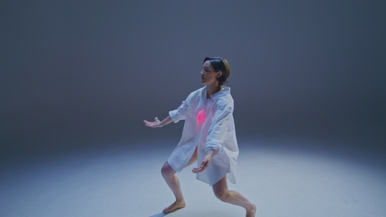 Talented ballerina dancing with a red light on her chest - Free Stock Video