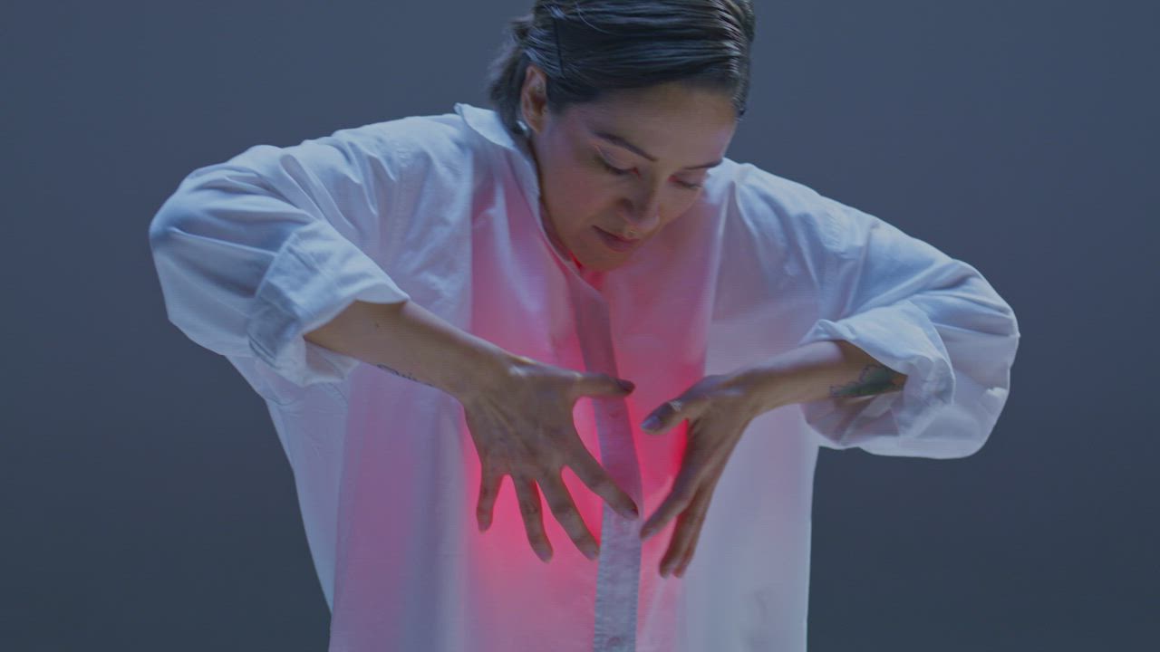 Contemporary dancer performance with light on her chest - Free Stock Video