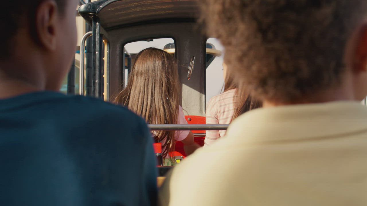 Children having fun aboard a small mechanical train - Free Stock Video