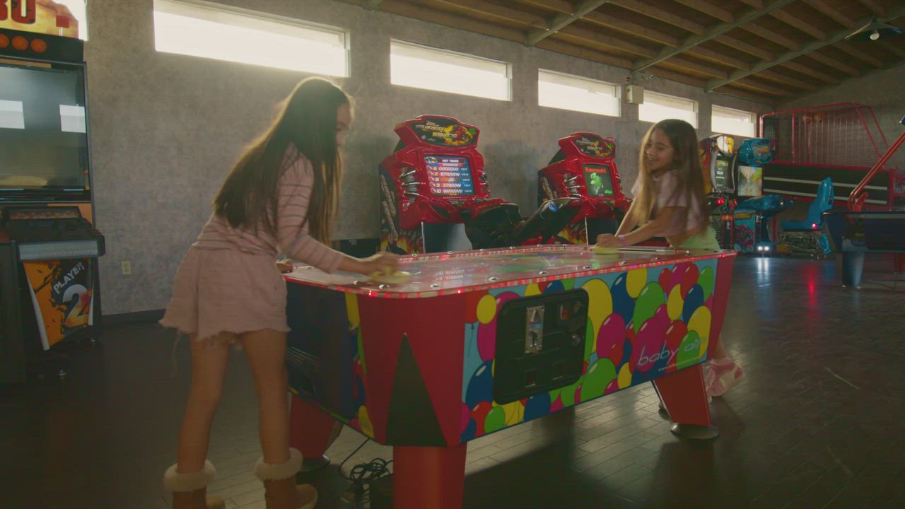 Two little girls having fun at the arcade shop - Free Stock Video