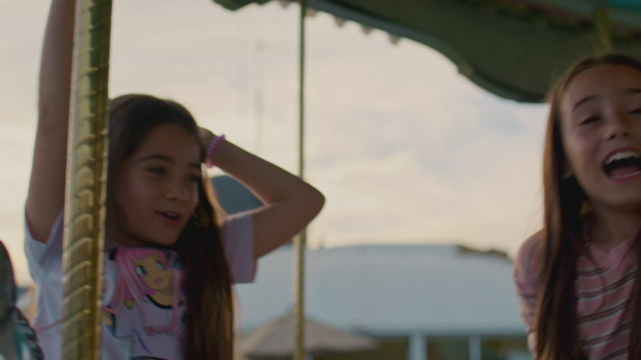 Two little girls laugh and enjoy the carousel ride at the fair. - Free ...