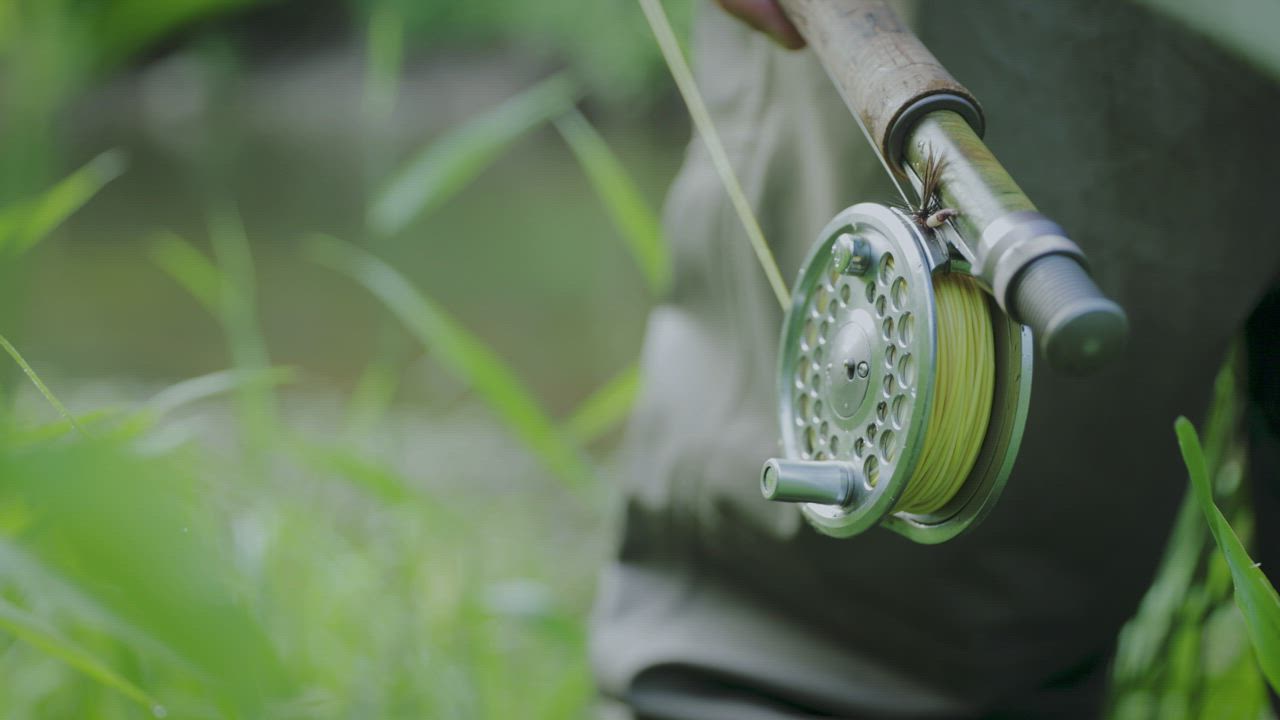 Close up of an angler's fishing rod and reel - Free Stock Video