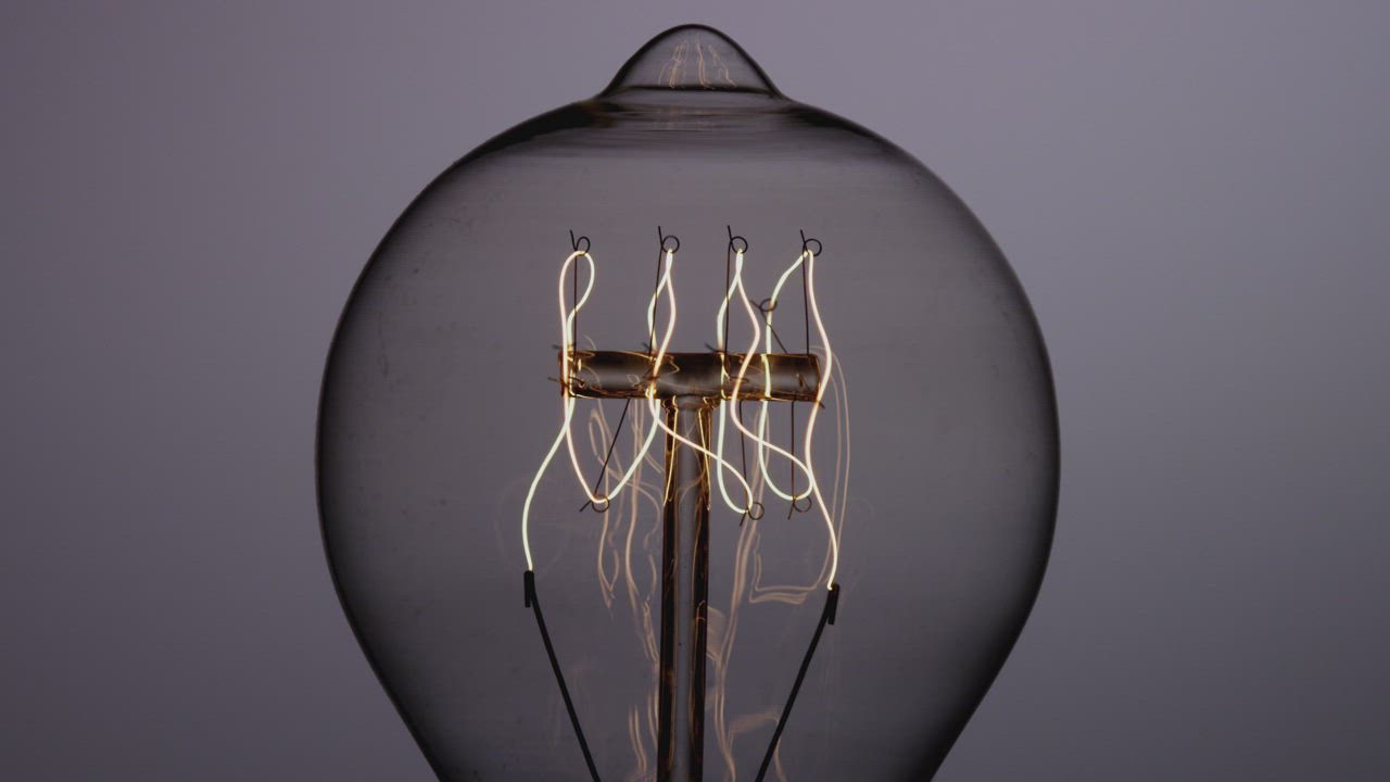 Light bulb filament lighting up - Free Stock Video