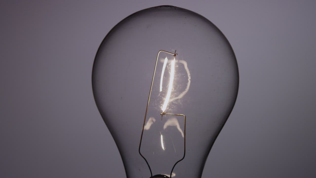 Large light bulb illuminating - Free Stock Video