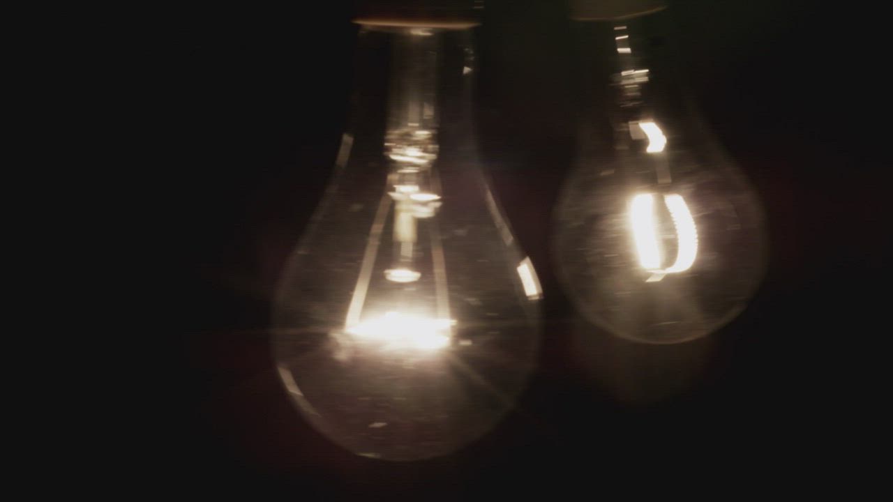 Two light bulbs swinging - Free Stock Video
