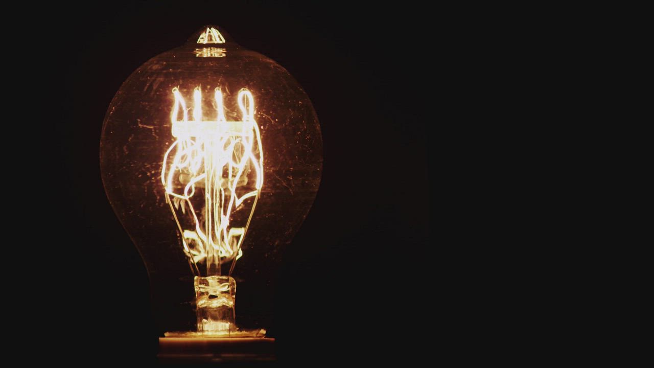 Light bulb illuminating in the dark - Free Stock Video
