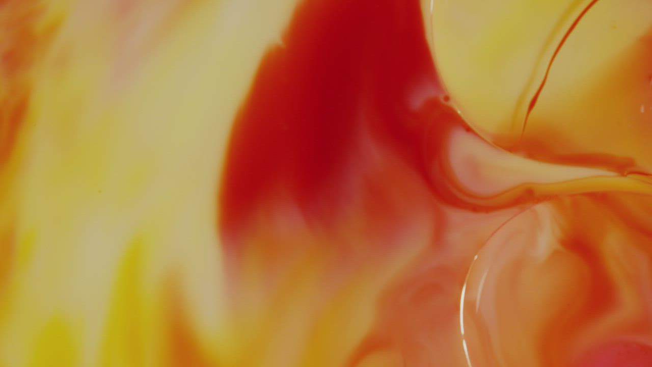 Orange liquid flowing hypnotically - Free Stock Video