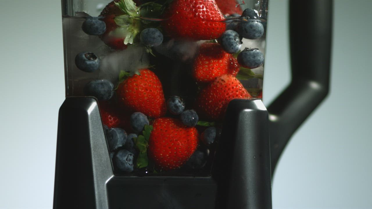 Slow motion fruit in a blender - Free Stock Video