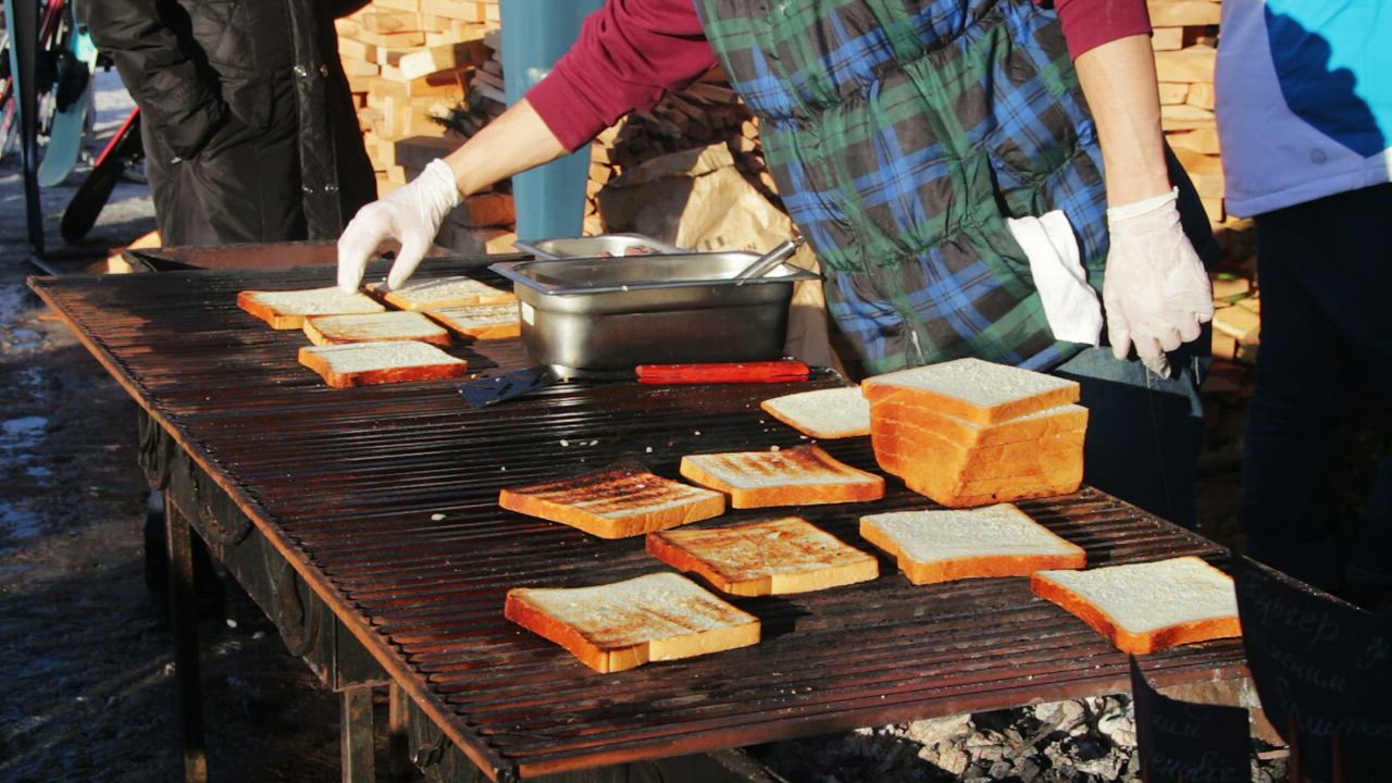 Woman making sandwiches on a grill - Free Stock Video