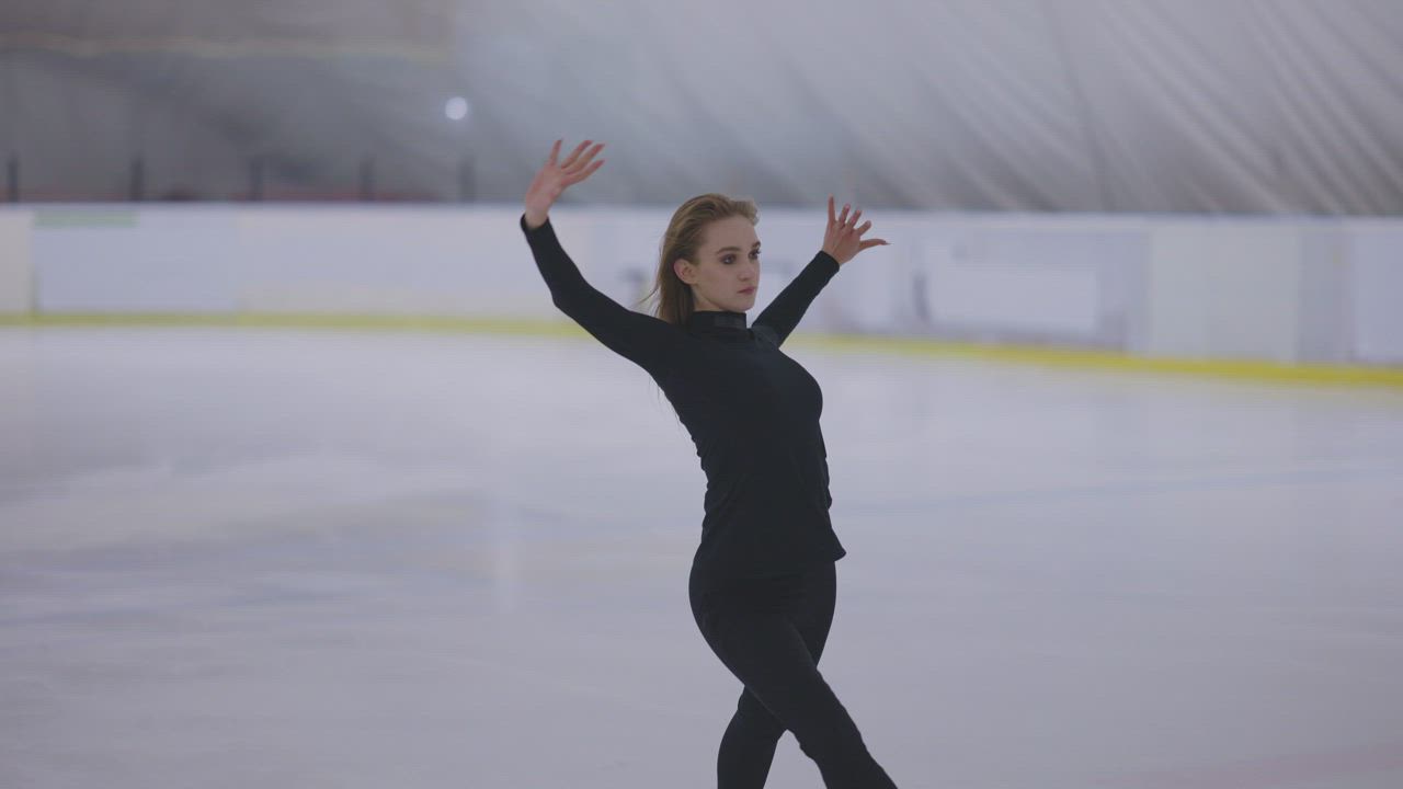 Girl skater practicing figure skating routine - Free Stock Video