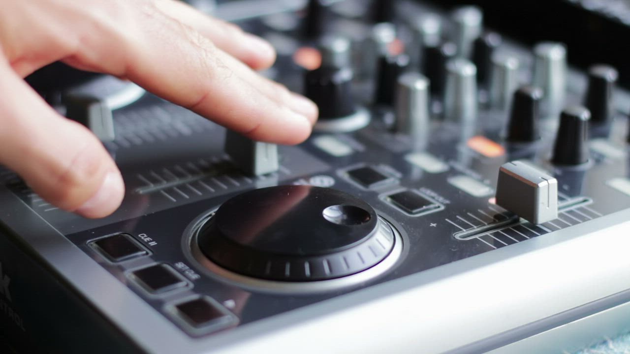 DJ working on his console - Free Stock Video