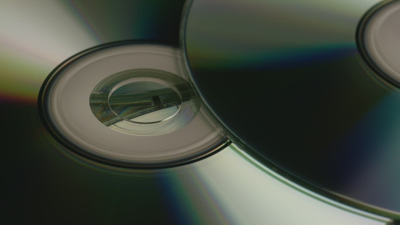 Two CD discs close up rotating - Free Stock Video