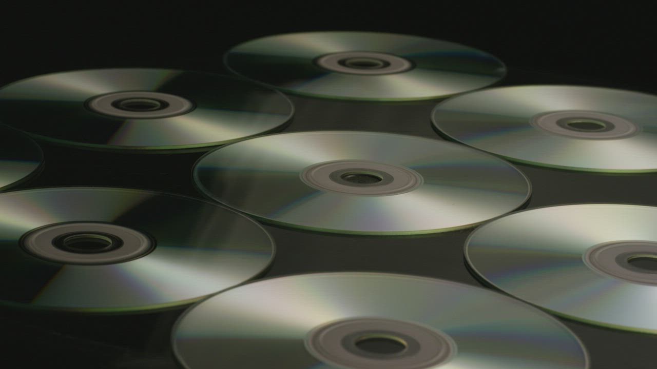 Three lines of compact discs on a black base - Free Stock Video