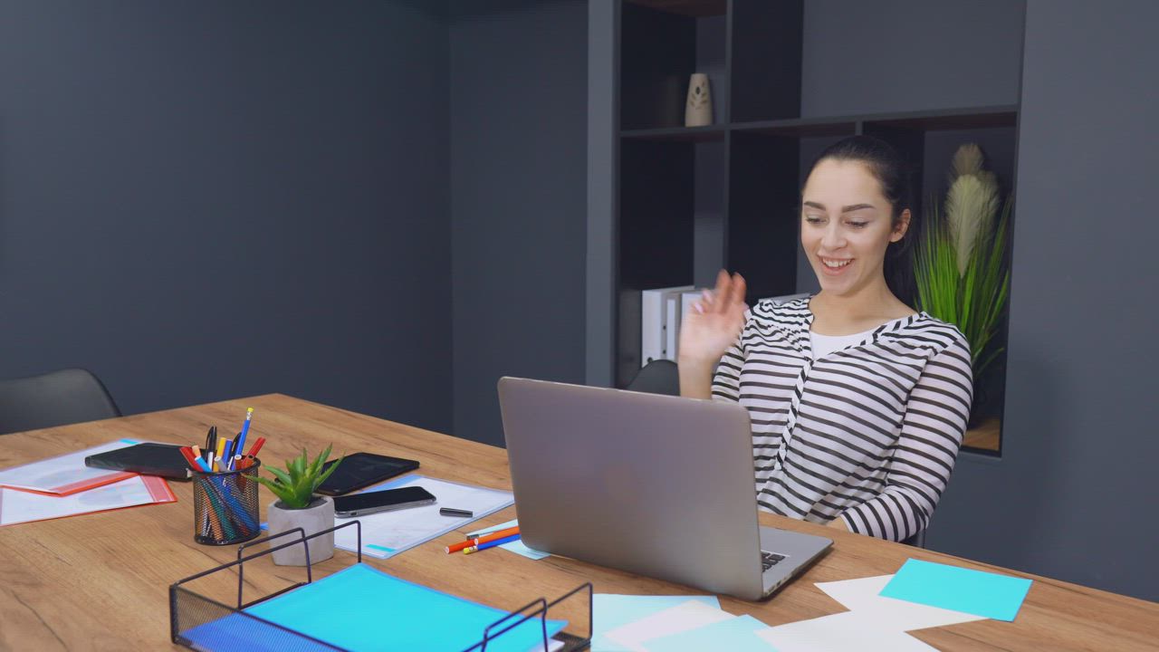 Young female employee having a video call with a client - Free Stock Video