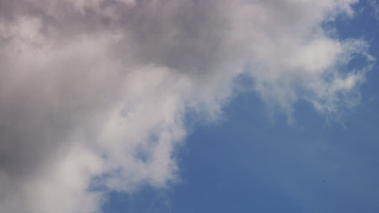 Rain clouds forming across the blue sky - Free Stock Video