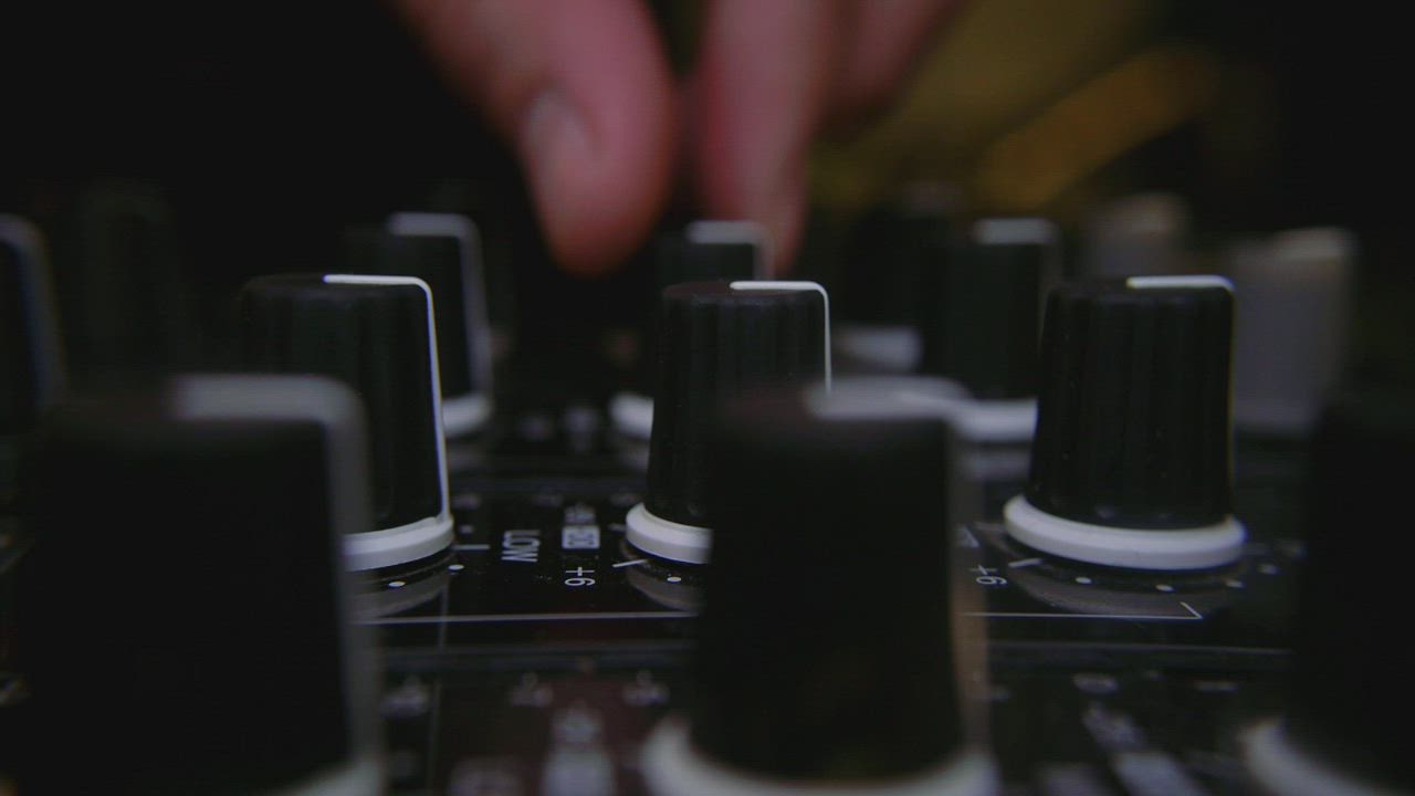 Close up of fingers adjusting controls on a music mixing desk - Free ...