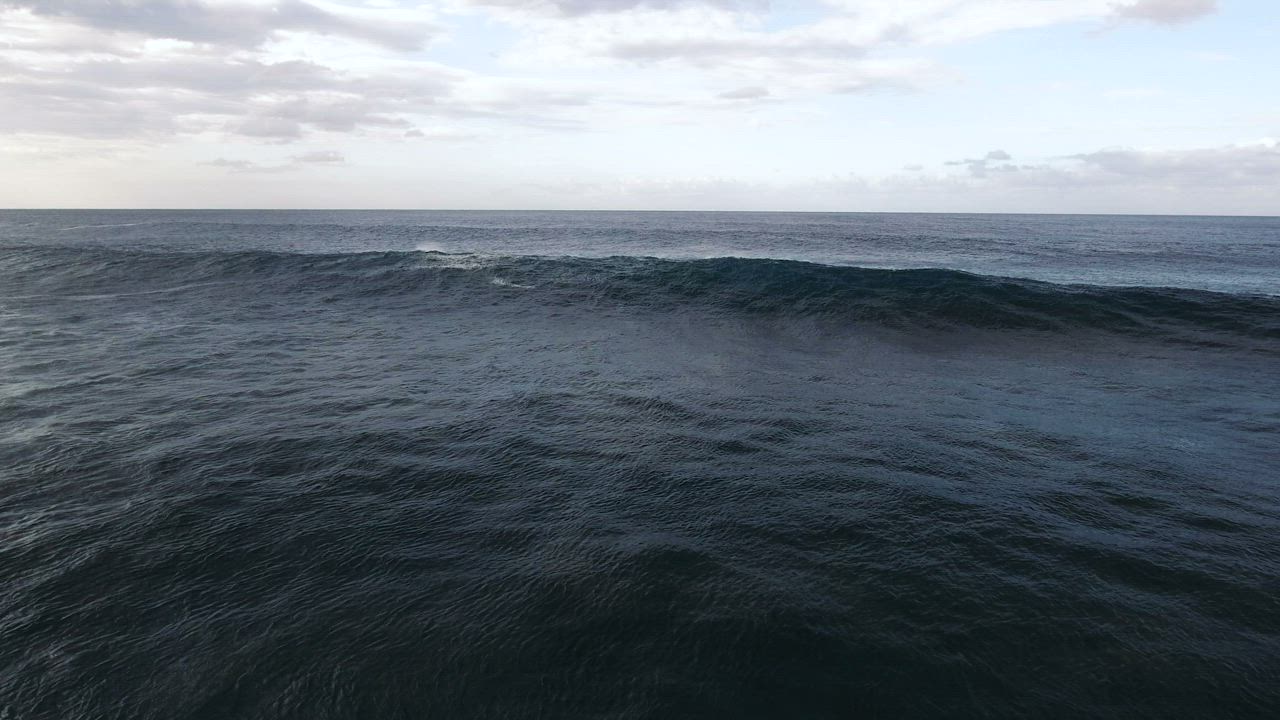 Aerial view of huge ocean wave breaking on shore reef - Free Stock Video