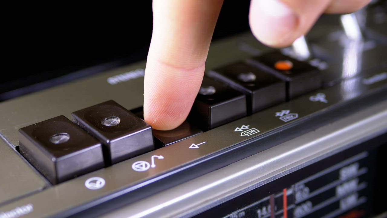 Man pushing play button on a vintage tape recorder - Free Stock Video