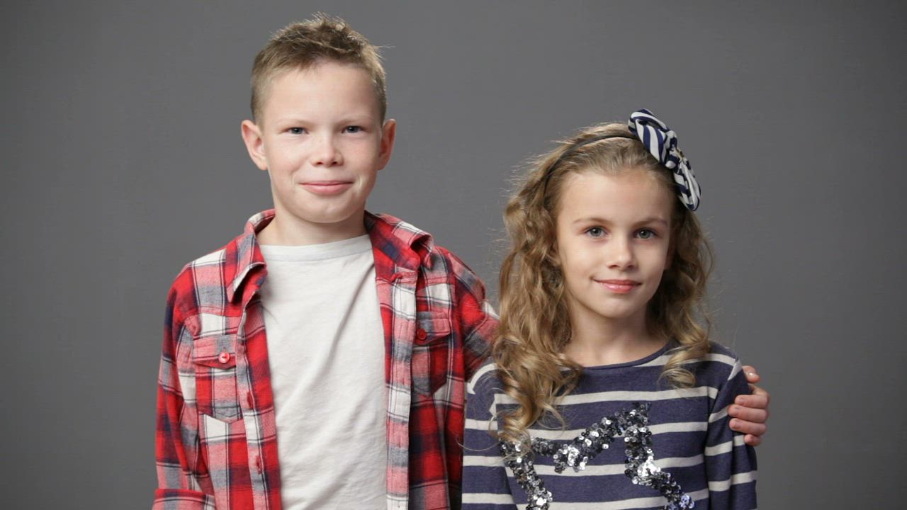 Two siblings posing for a photo together - Free Stock Video