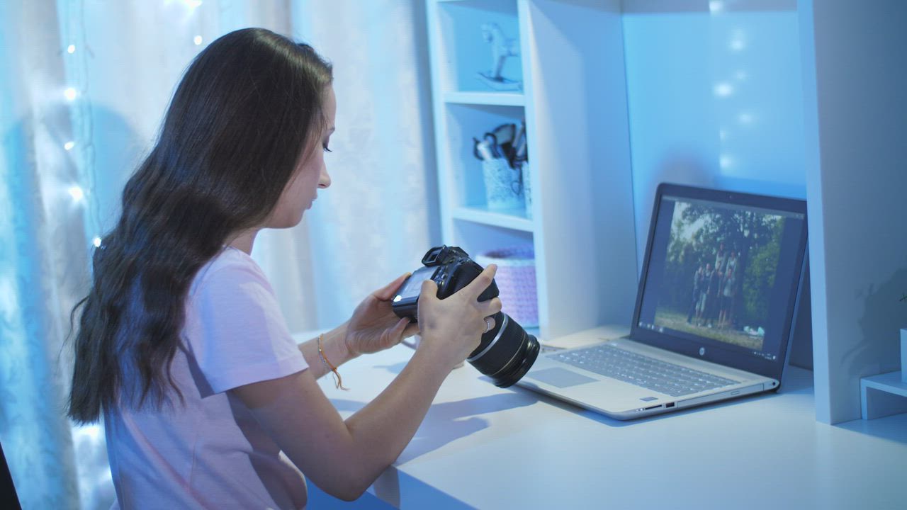 Photographer editing her photos on her laptop - Free Stock Video