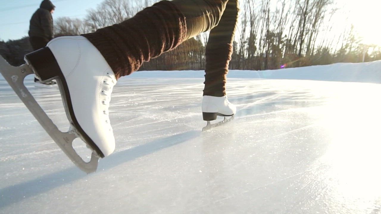 Close up of someone skating on an outdoor ice rink - Free Stock Video