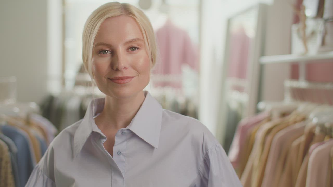 Retail worker smiling at the camera at a clothes shop - Free Stock Video