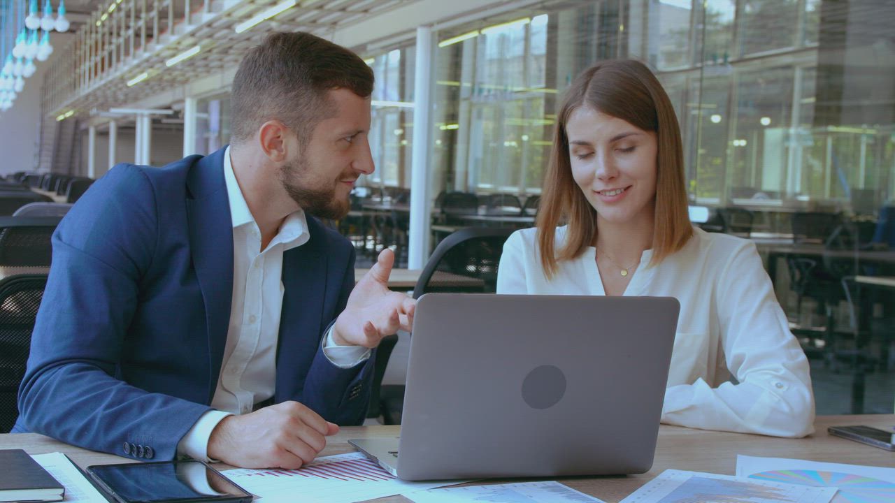 Two coworkers talking and laughing - Free Stock Video