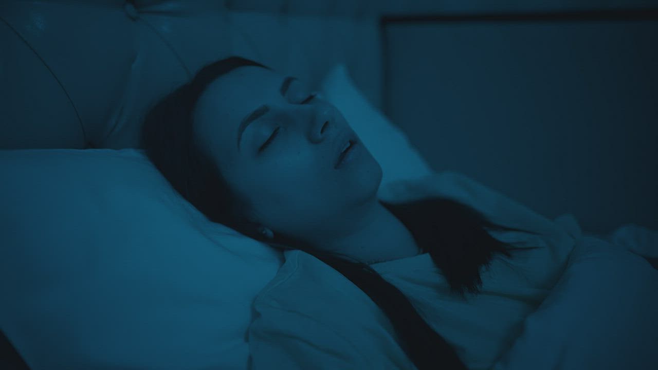 Woman sleeping on her back at night - Free Stock Video