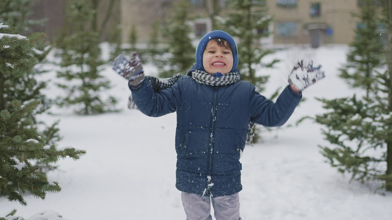 Young boy clapping hands excitedly in the snow - Free Stock Video