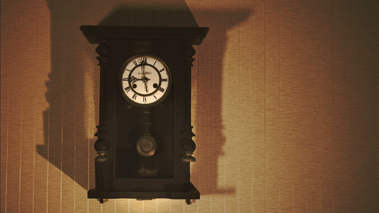 Vintage wooden clock sitting on a wall - Free Stock Video