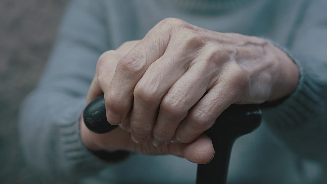 Elderly person gripping the handle of their walking cane - Free Stock Video