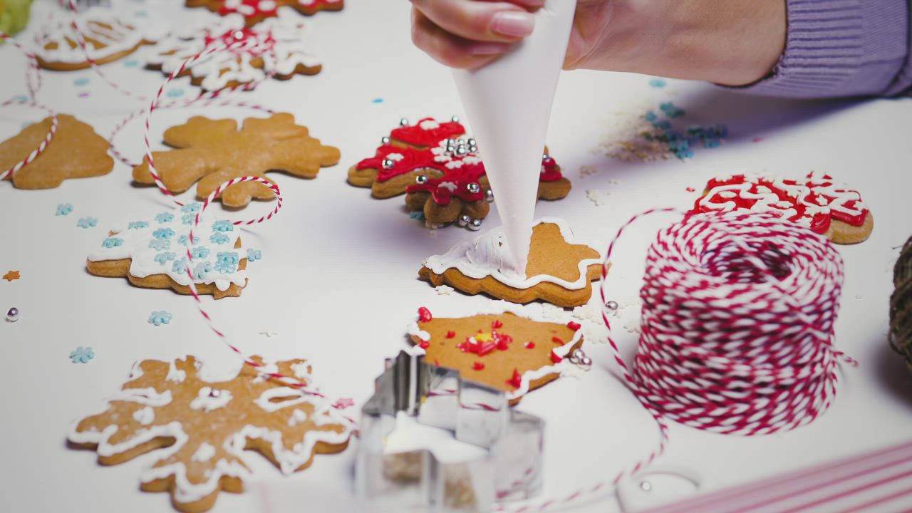 Gingerbread cookies being decorated for Christmas time - Free Stock Video