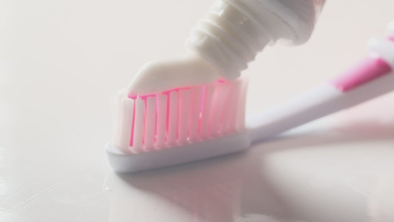Applying toothpaste on toothbrush - Free Stock Video