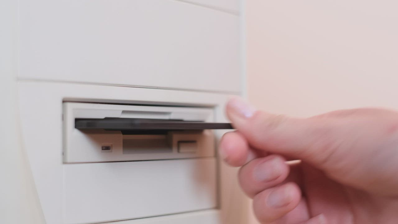 Floppy disk being inserted into the system unit - Free Stock Video