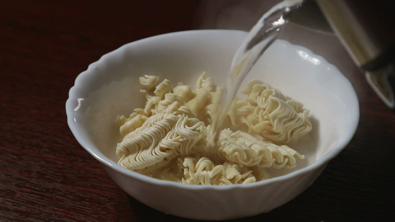 Hot water served in a dish with noodles - Free Stock Video