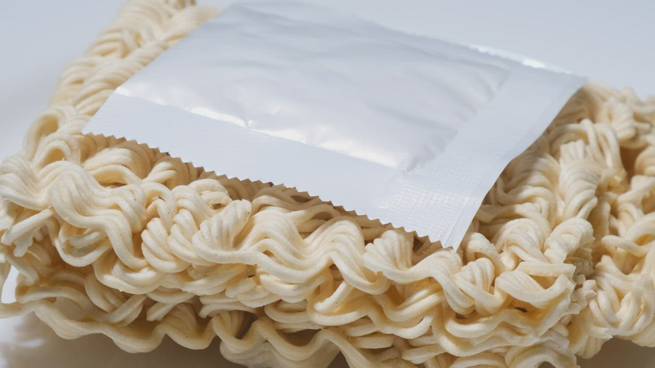 Instant noodles on white rotary surface - Free Stock Video