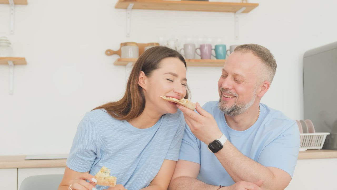 Happy couple sharing time together while eating pizza - Free Stock Video